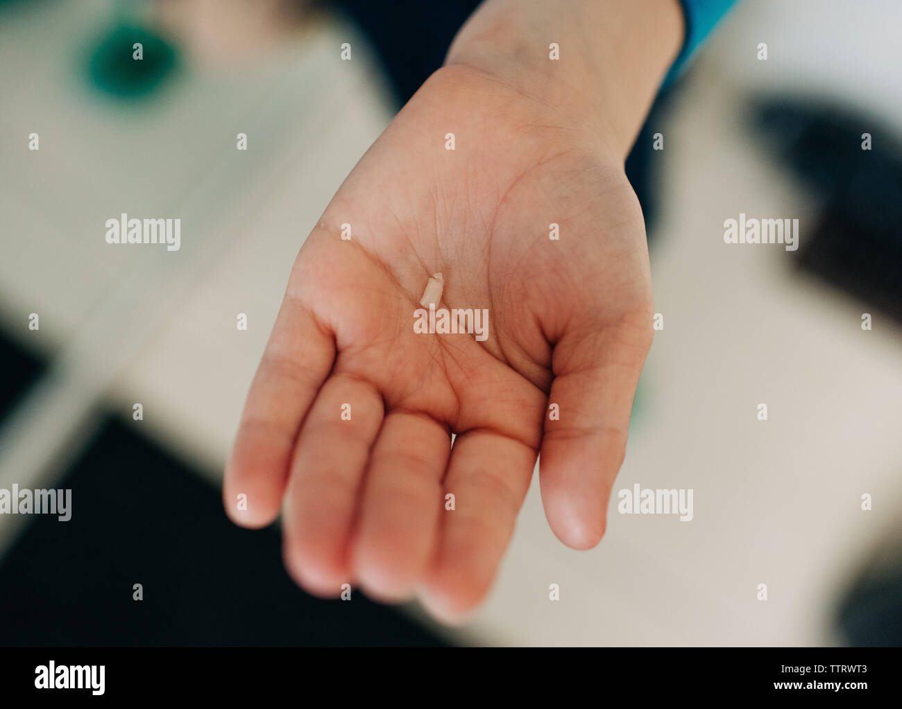young child holding their first baby tooth that has fallen out Stock ...