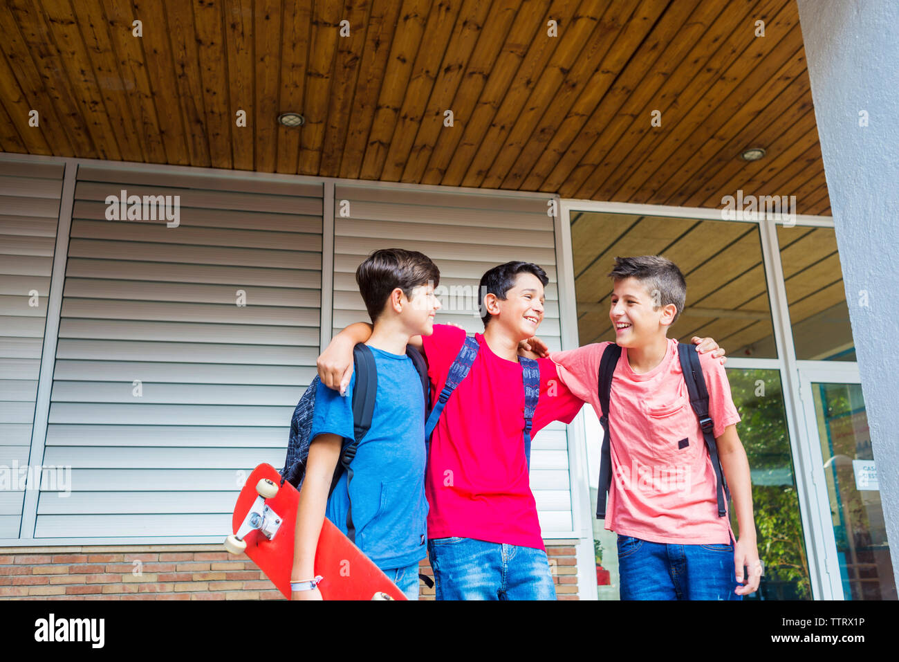 Happy students standing arms around hi-res stock photography and images ...
