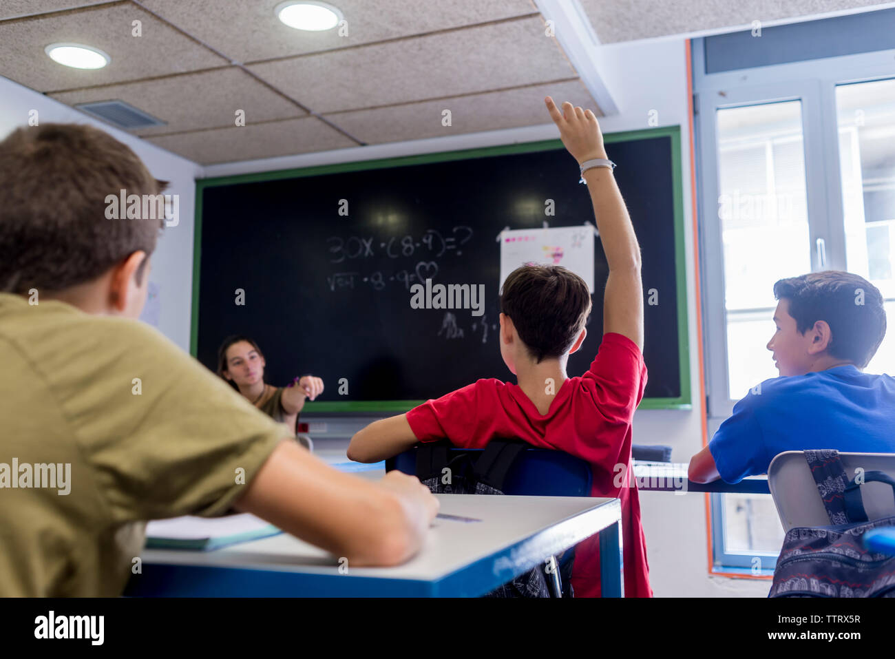 Female teacher interacting with students in classroom Stock Photo - Alamy Female teacher interacting with students in classroom Stock Photo - Alamy