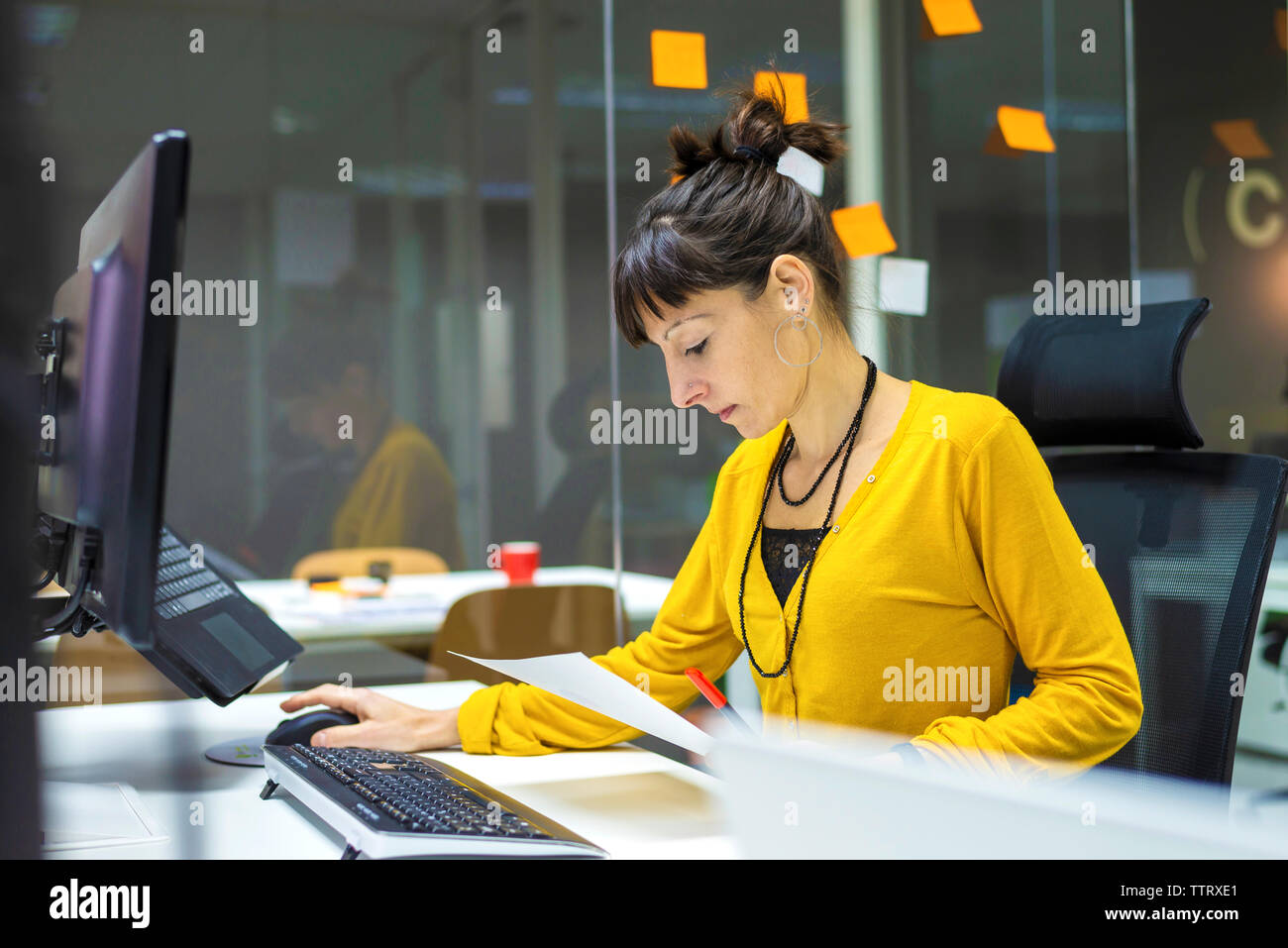 Side view of businesswoman using computer in creative office Stock ...