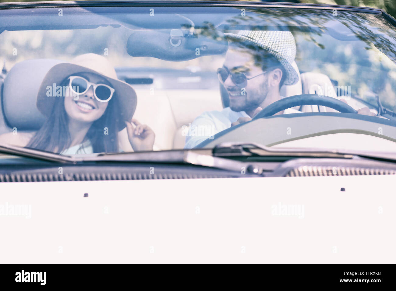 Couple driving car on road trip Stock Photo - Alamy