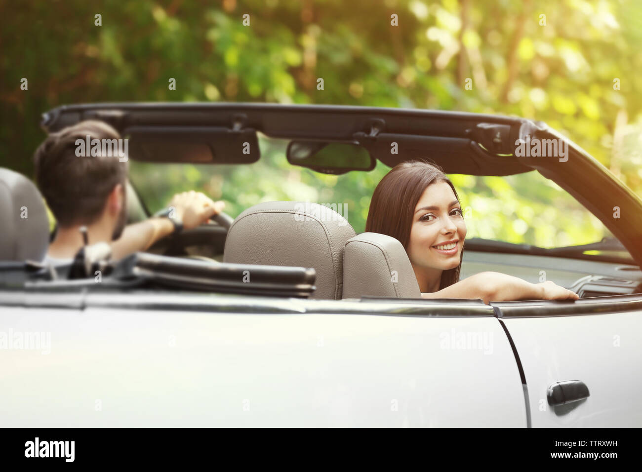 Beautiful woman in car on road trip Stock Photo - Alamy