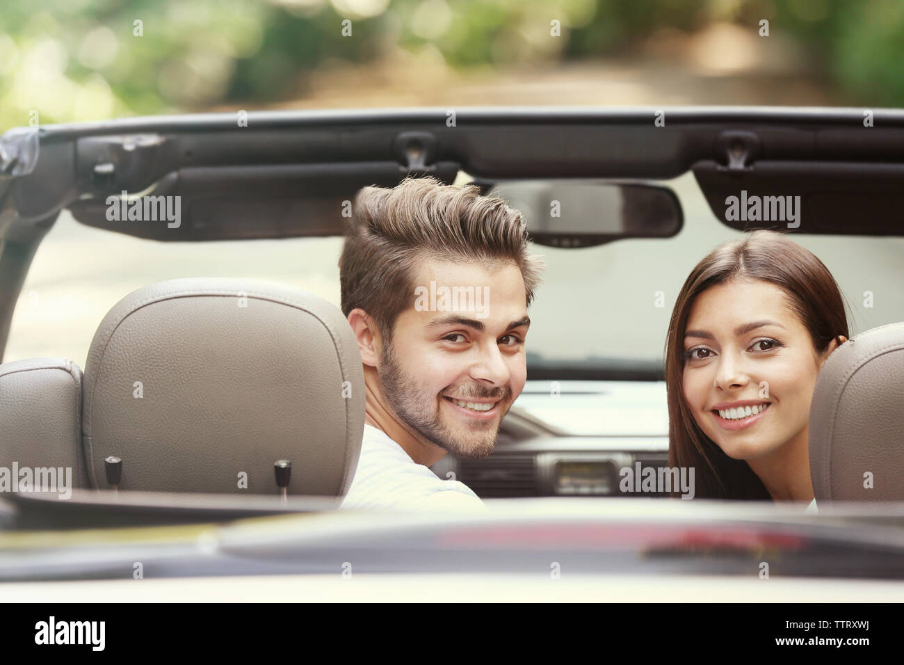 Beautiful couple in car on road trip Stock Photo - Alamy