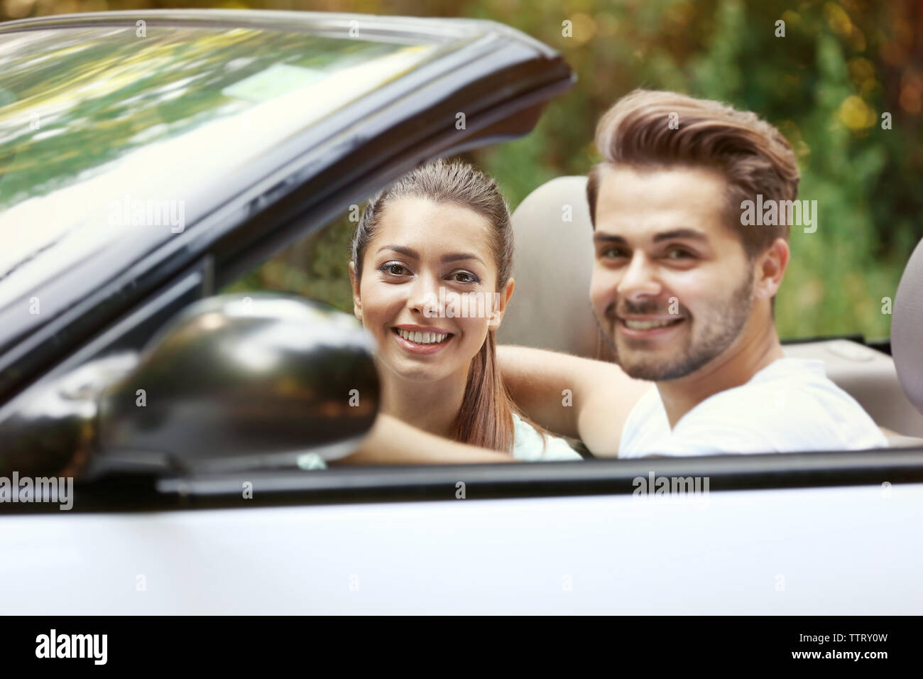 Beautiful couple in car on road trip Stock Photo - Alamy