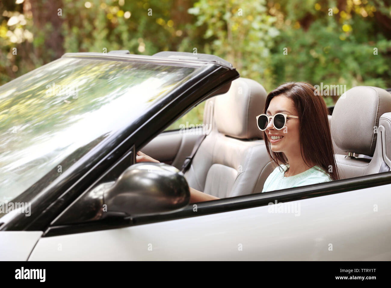 Beautiful woman driving car on road trip Stock Photo - Alamy