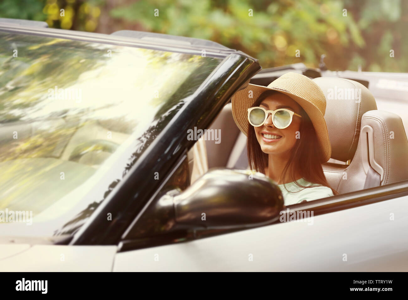 Beautiful woman driving car on road trip Stock Photo - Alamy