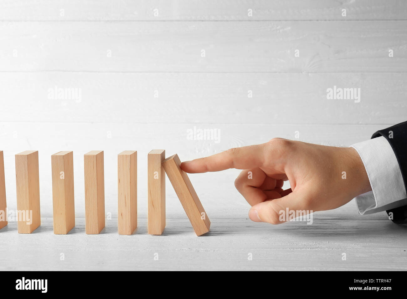 Finger pushing dominoes hi-res stock photography and images - Alamy