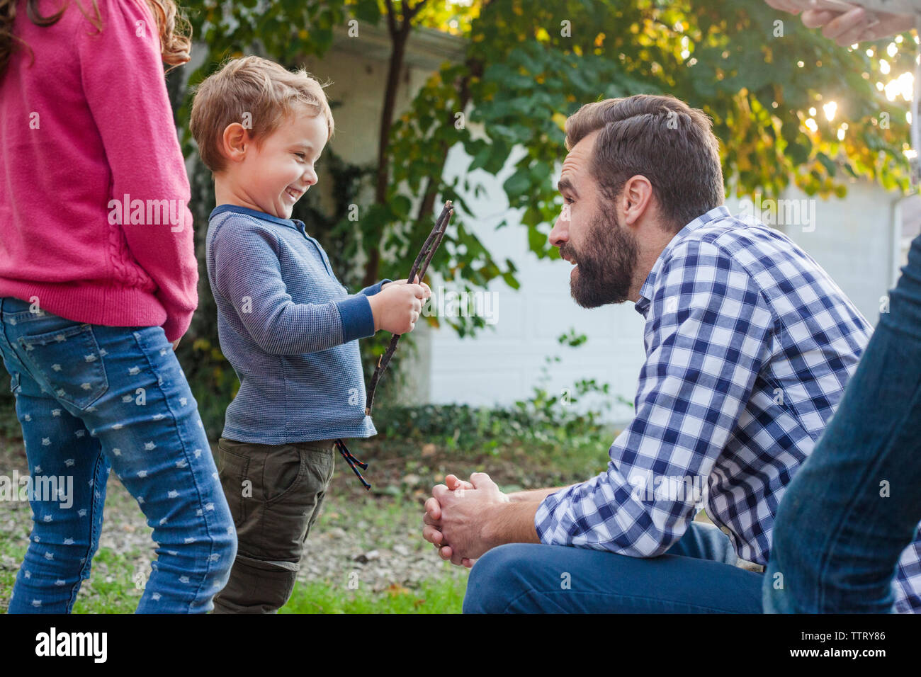 Father playing with children in yard Stock Photo - Alamy