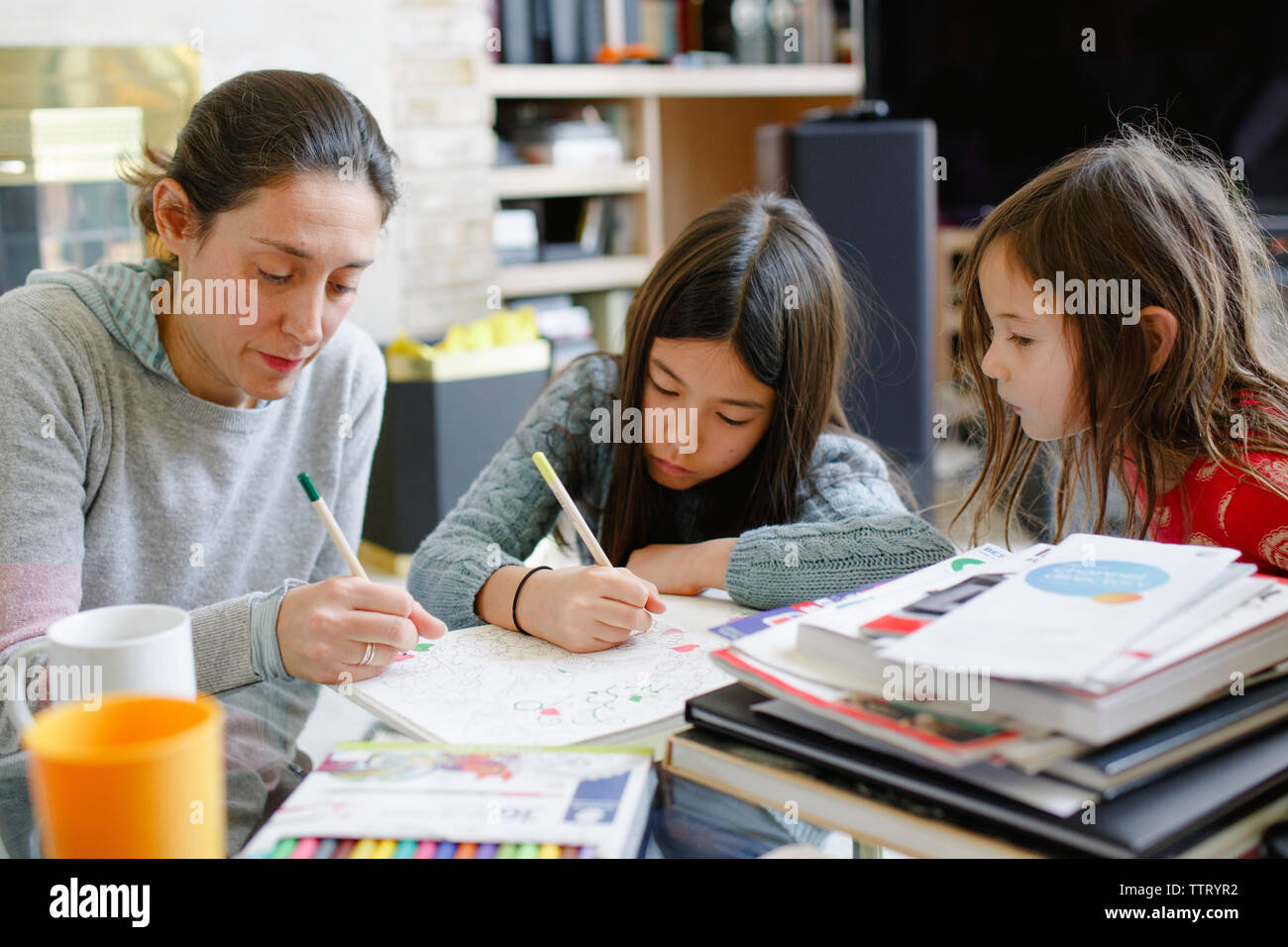Children doing homework with Mom at home Stock Photo - Alamy