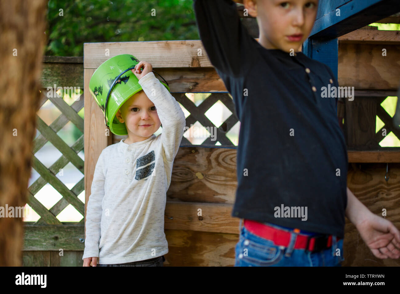 Two young brothers play together in a treehouse Stock Photo - Alamy