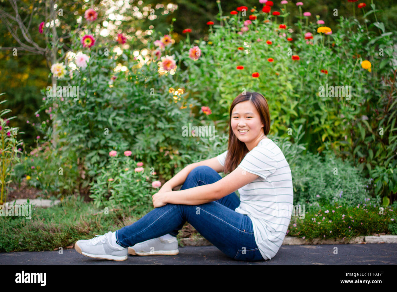 Girl sitting in flowers hi-res stock photography and images - Alamy