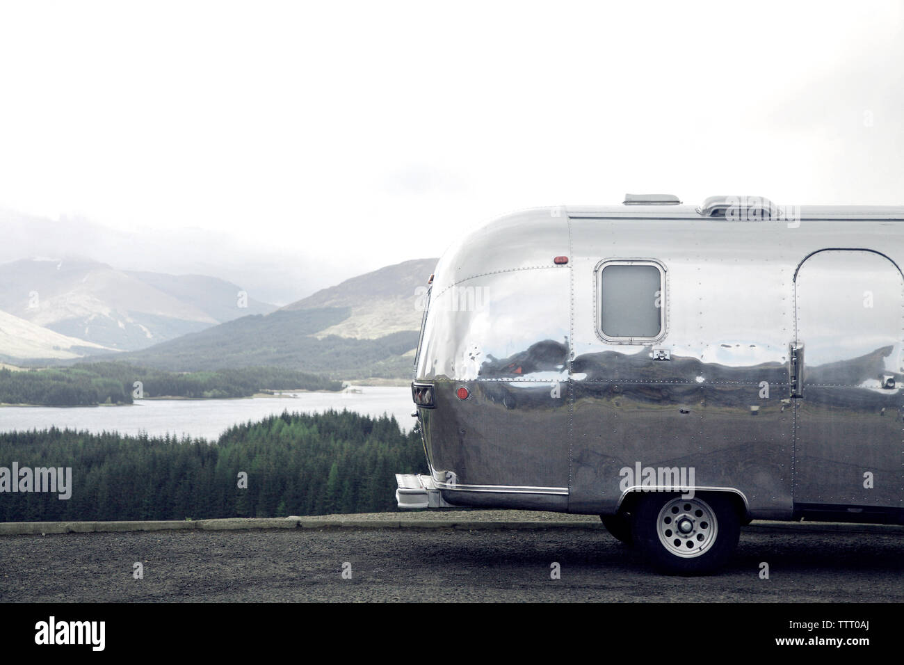 Trailer home on street with mountains and lake in background Stock ...