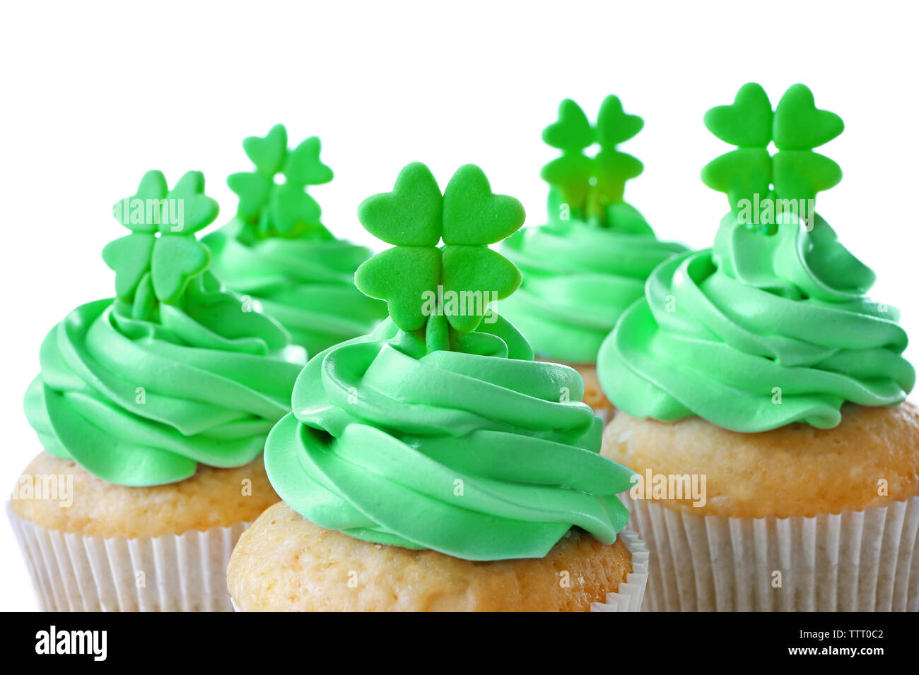 Tasty cupcakes with clover, on white background. Saint Patrics Day ...