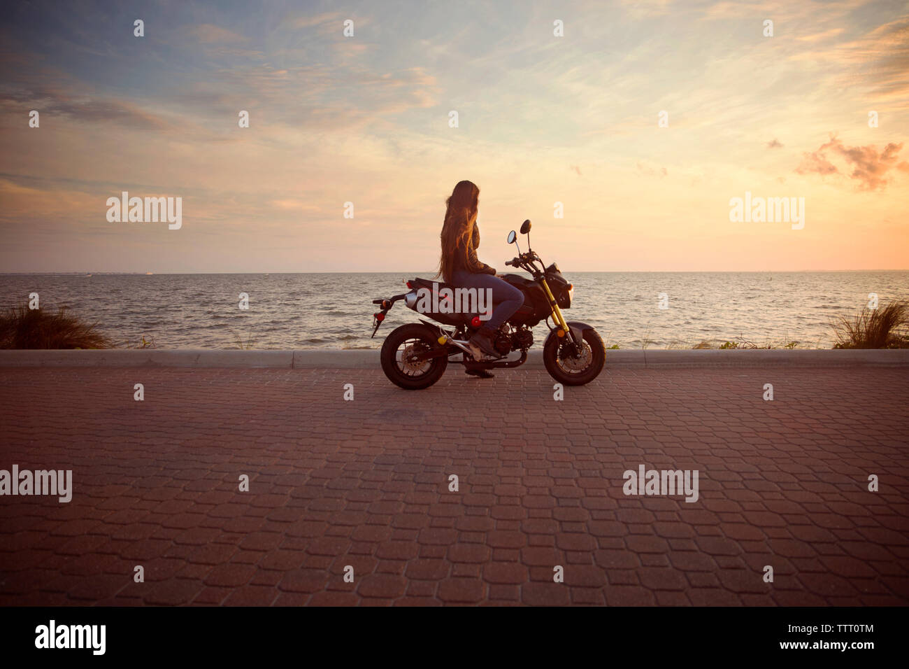 Woman riding motorcycle side view hi-res stock photography and images ...