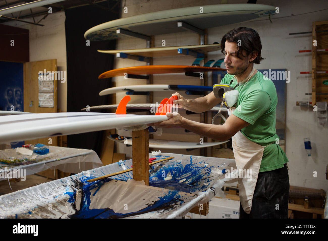 Concentrated worker making surfboard in workshop Stock Photo - Alamy