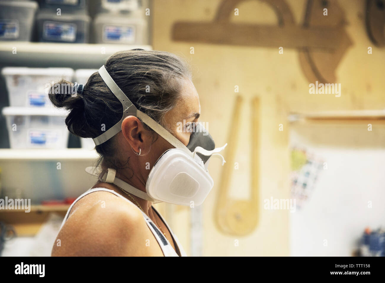 Side view of woman in workshop Stock Photo - Alamy