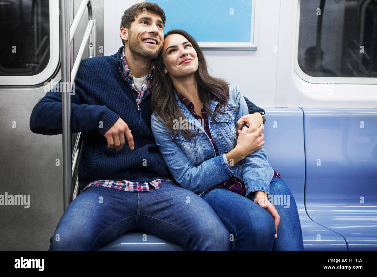 Happy couple traveling in train Stock Photo - Alamy