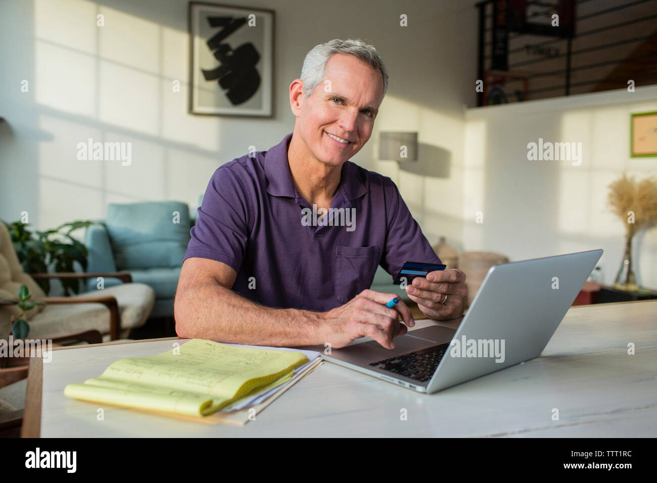 Portrait smiling mature man laptop sitting table home hi-res stock ...