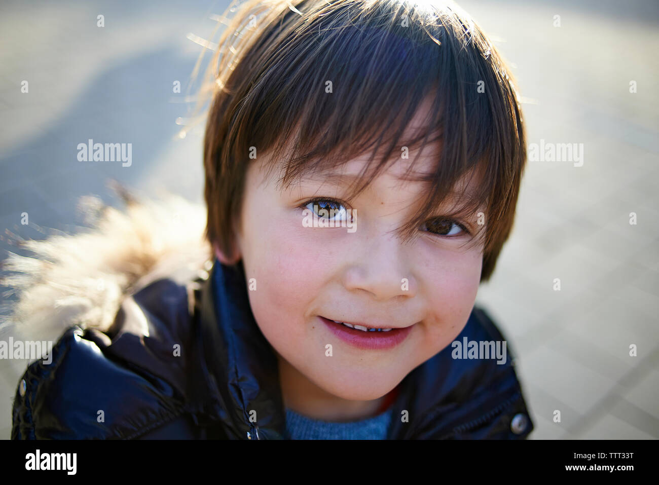 High angle portrait of confident boy standing on footpath Stock Photo ...