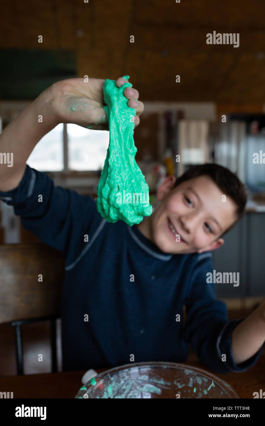 Slime falling out of boy's hand Stock Photo - Alamy