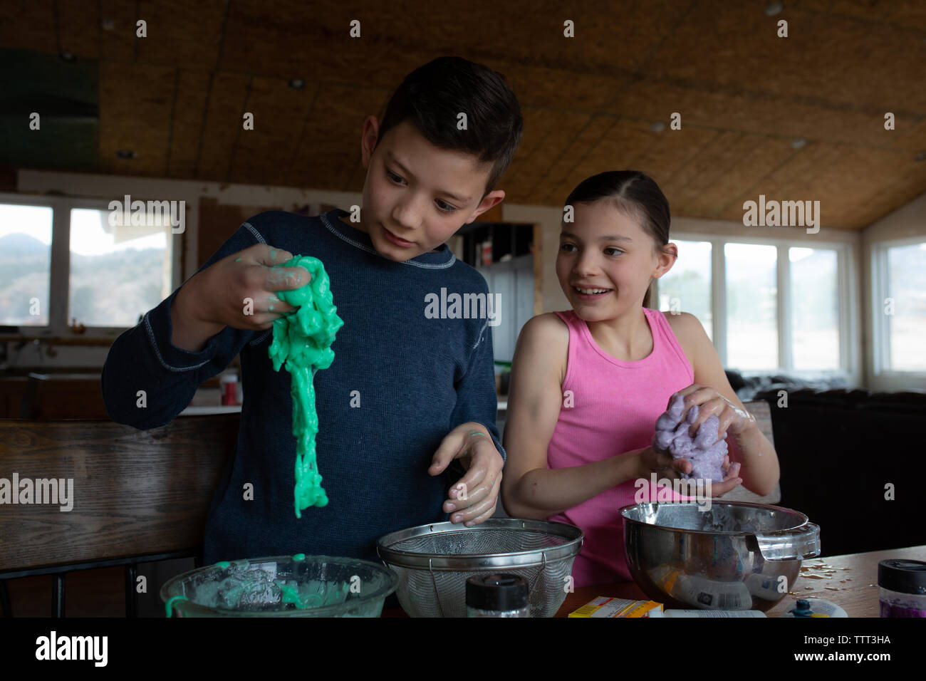 Kids laughing while playing with the slime they made Stock Photo - Alamy