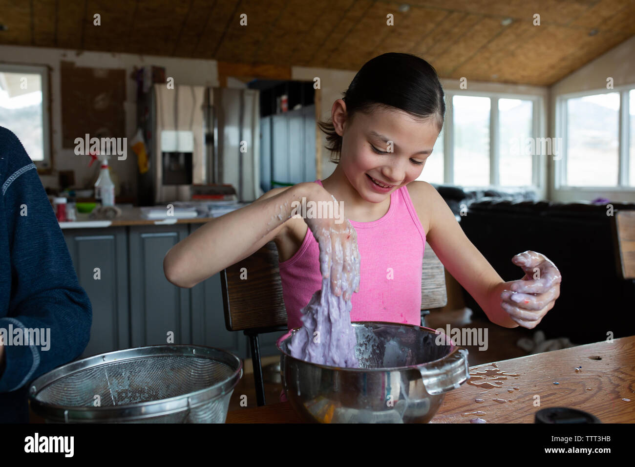 Tween girl playing with slime she just made Stock Photo - Alamy