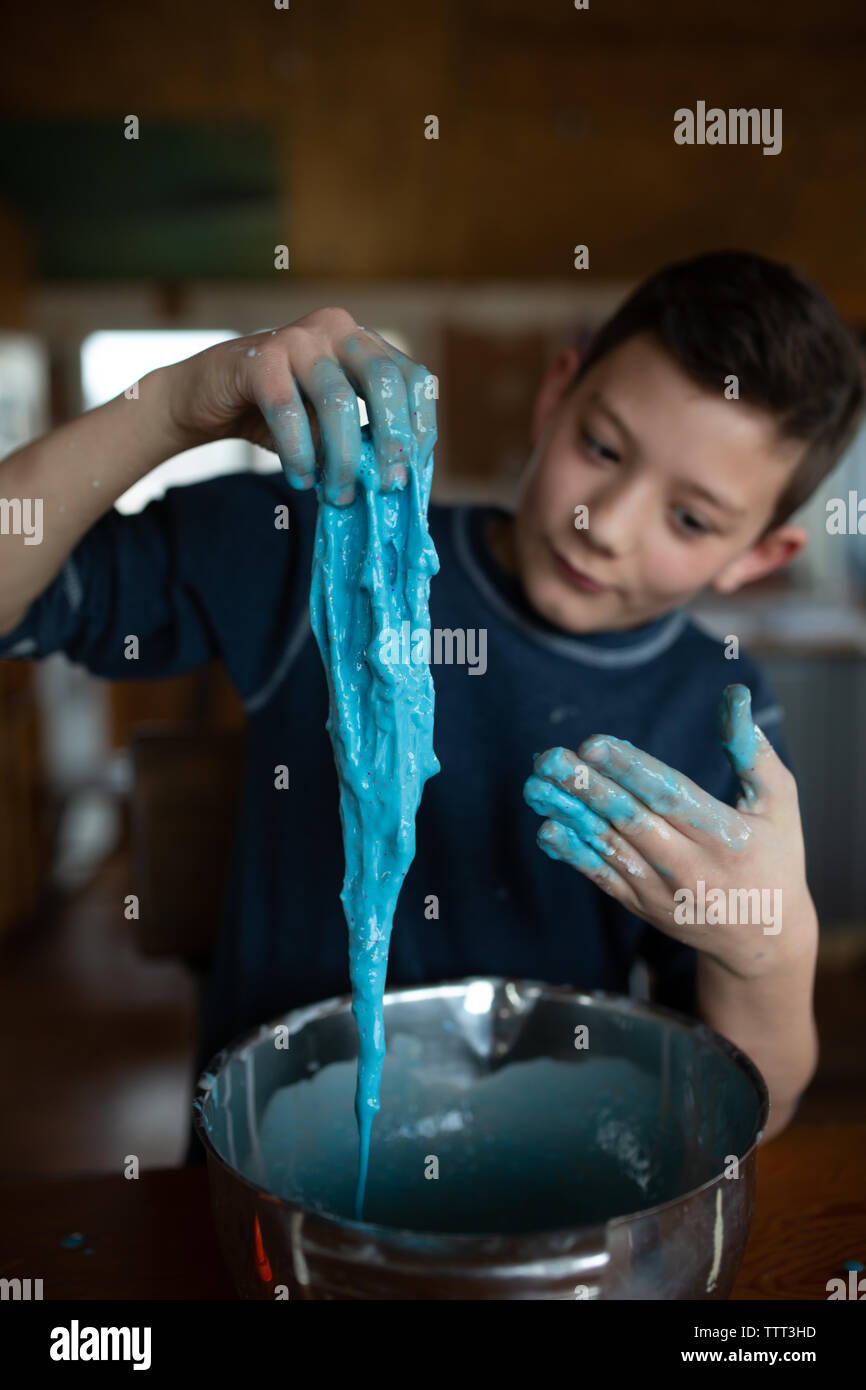 boy playing with blue slime in his hands Stock Photo - Alamy