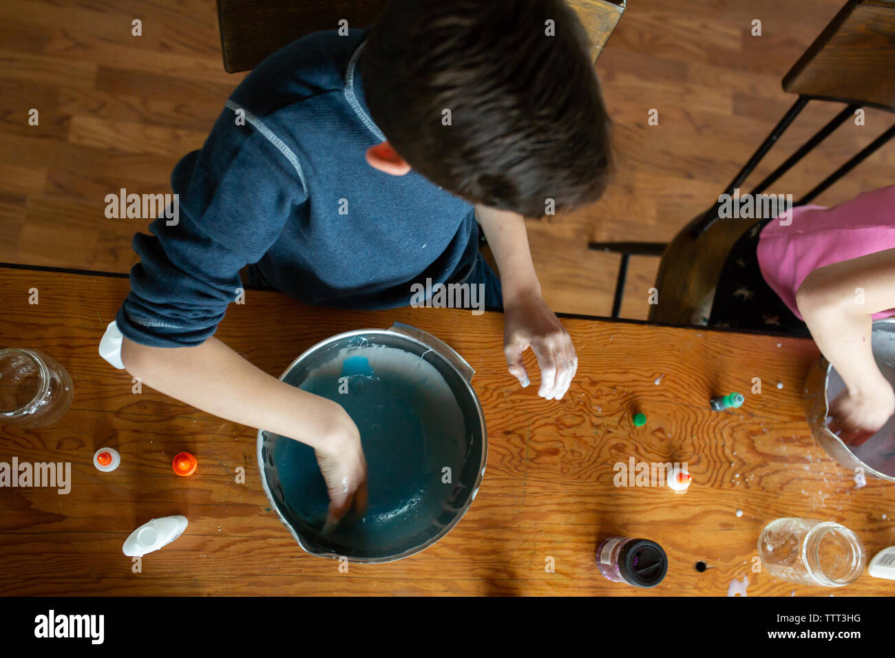 Tween siblings making slime at home Stock Photo - Alamy
