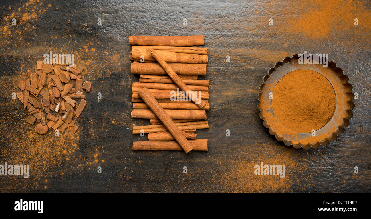 Overhead view of cinnamon sticks and powder on table Stock Photo - Alamy