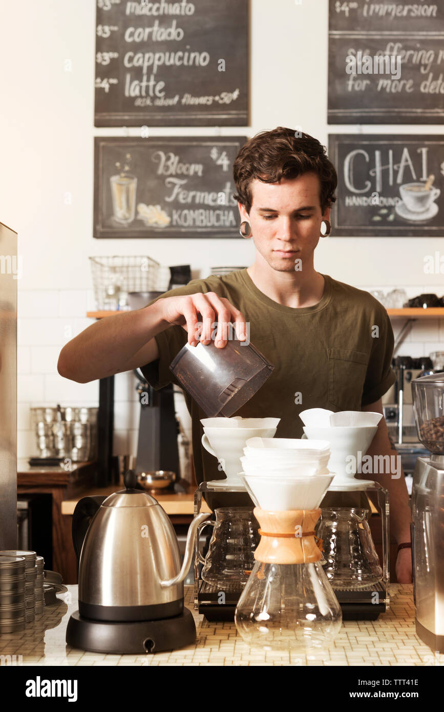 Man making coffee in coffee shop Stock Photo - Alamy