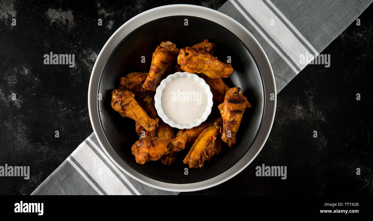 Overhead view of chicken wings in plate served on table Stock Photo - Alamy