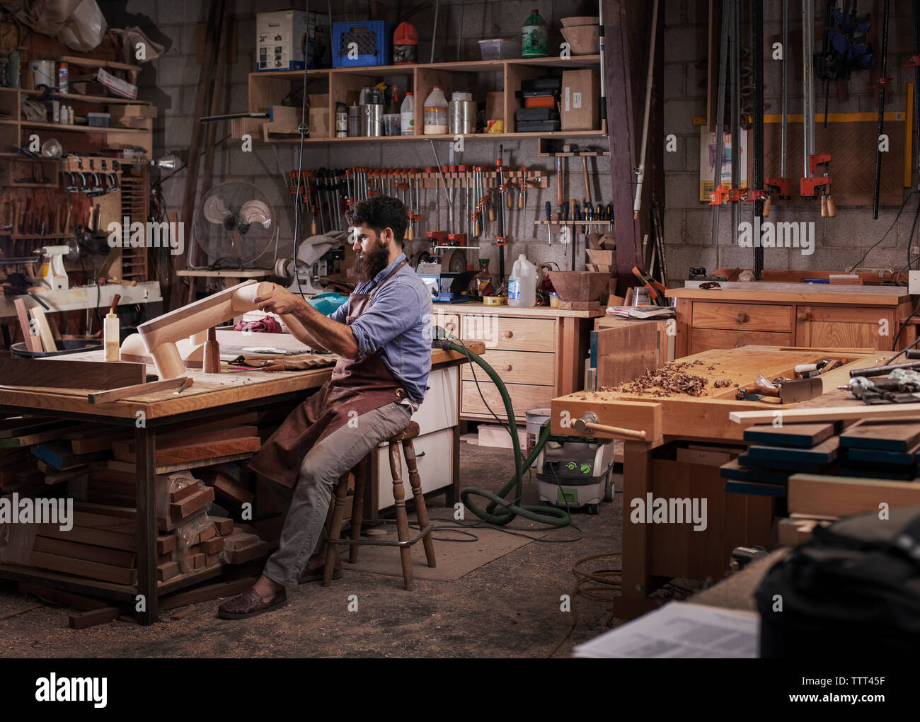 Serious Carpenter working at workshop Stock Photo - Alamy