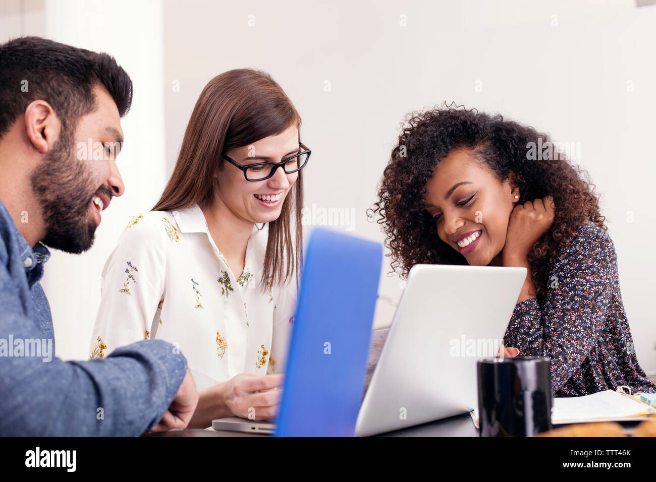 Happy business colleagues working at office Stock Photo - Alamy