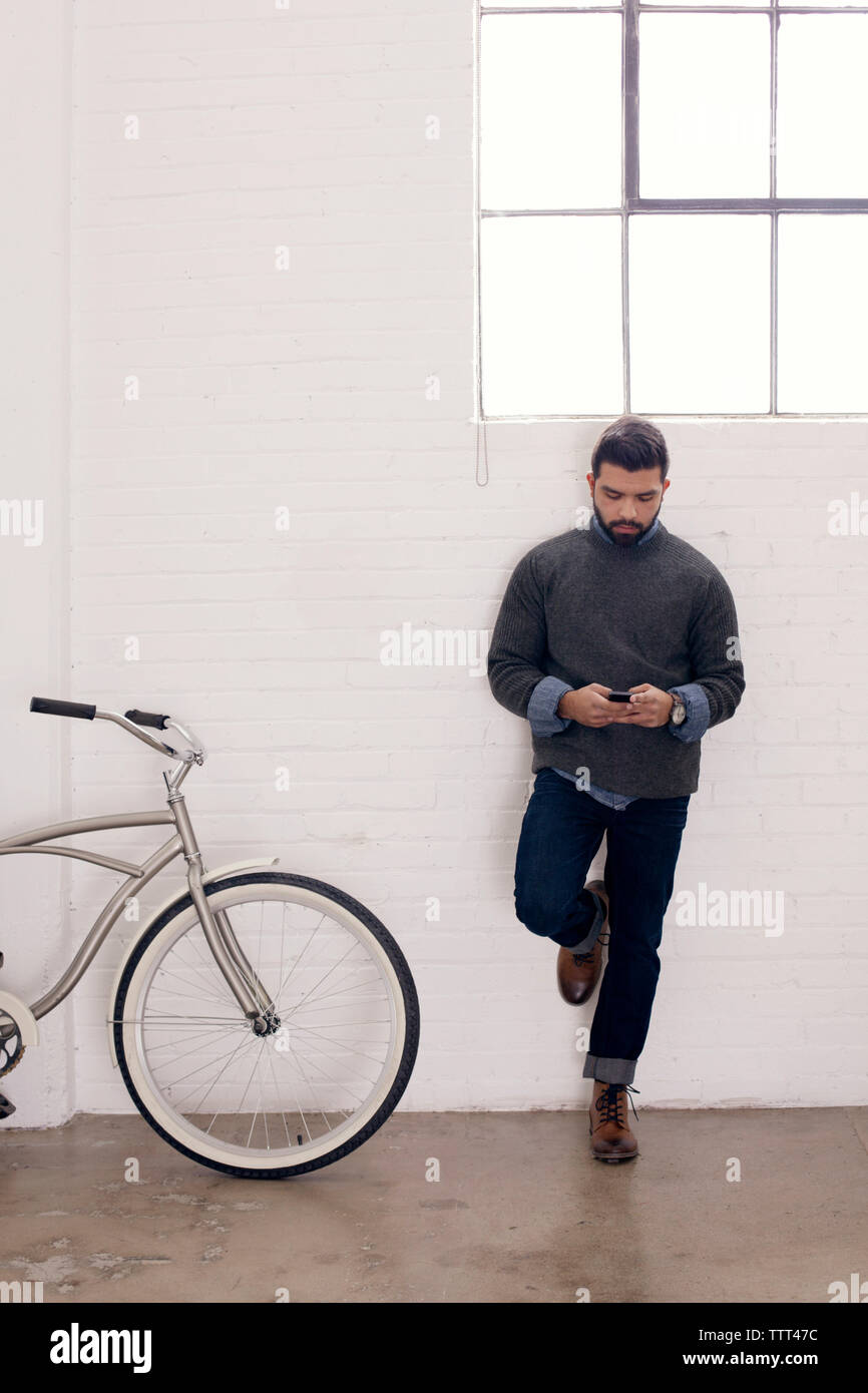 Businessman Leaning Against Office Wall High Resolution Stock ...