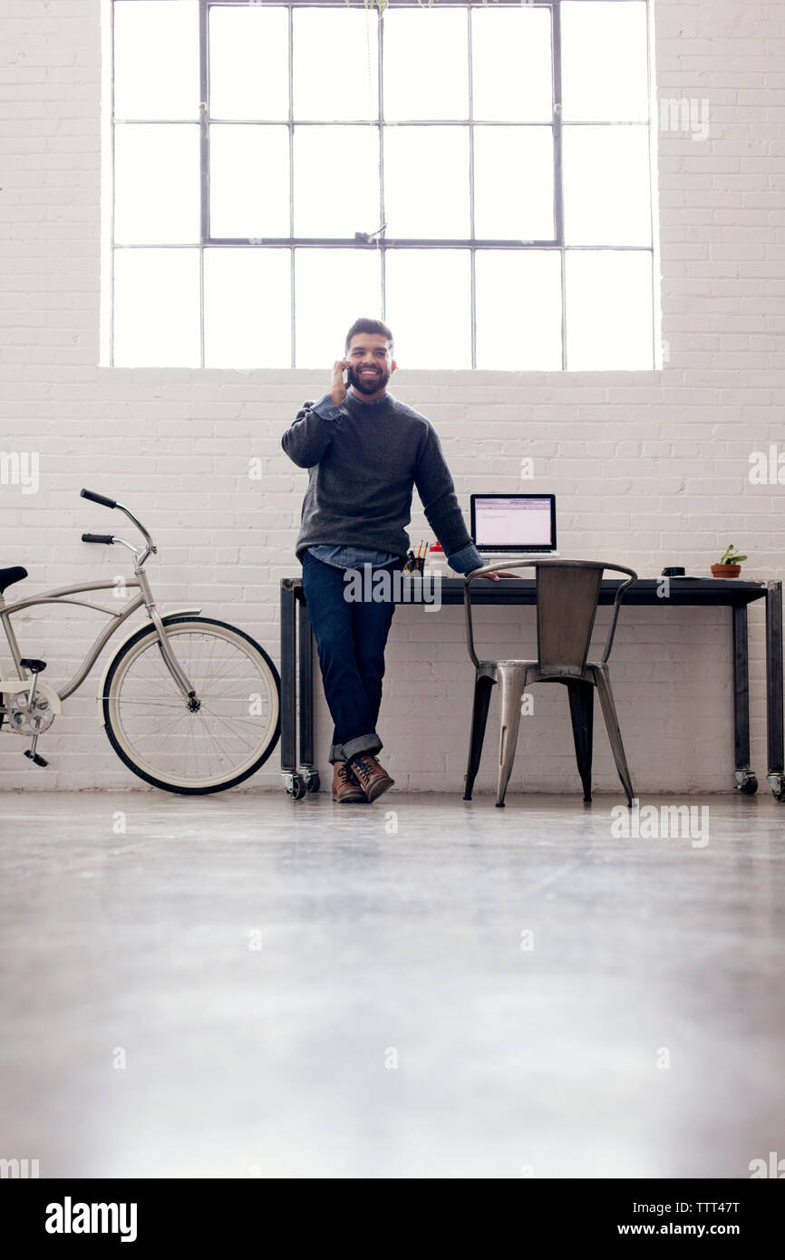 Young man leaning against table hi-res stock photography and images - Alamy