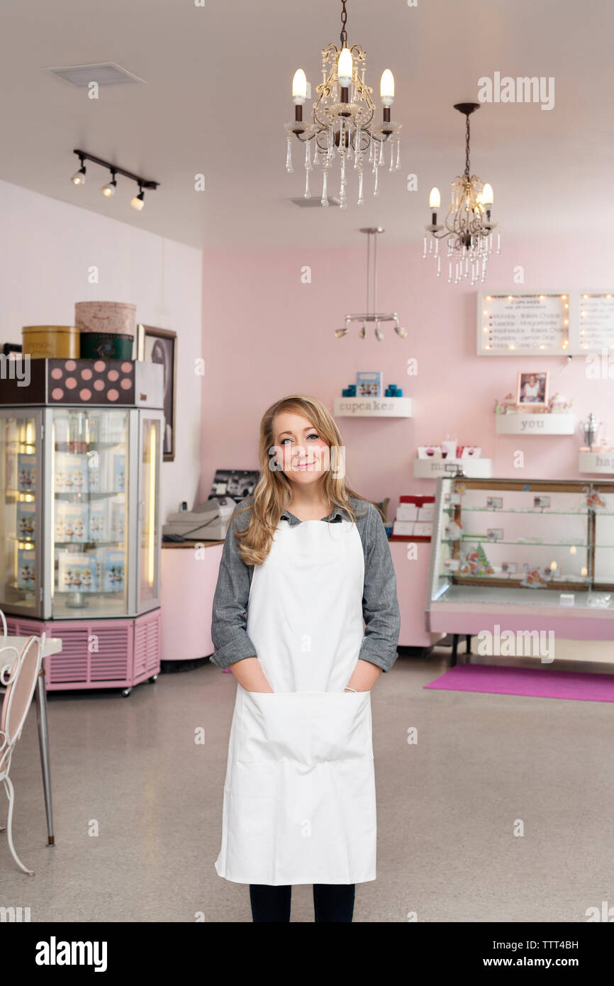 Portrait of owner standing in cake shop Stock Photo - Alamy