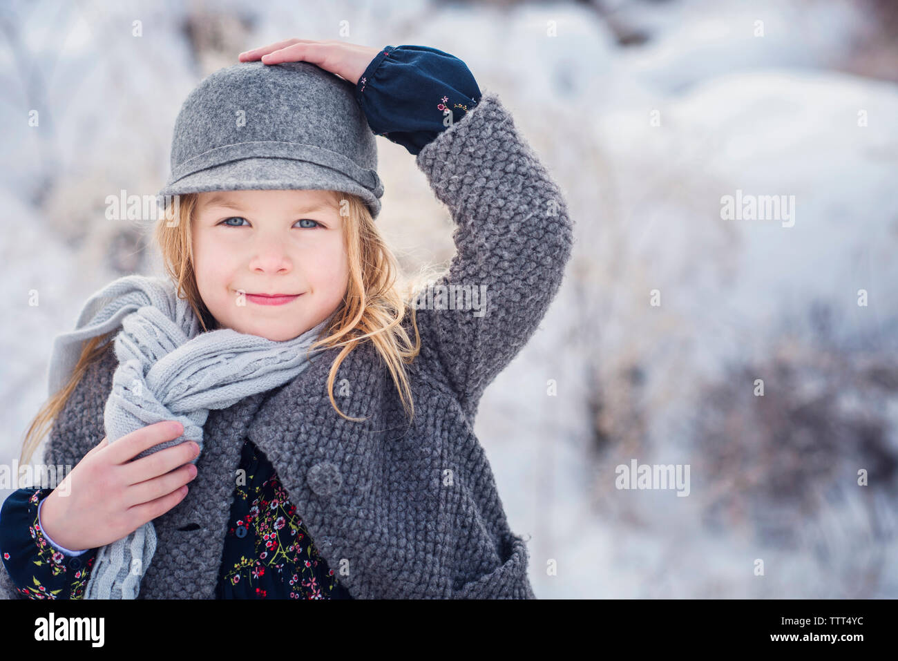 Portrait of cute girl wearing warm clothing standing on field during ...