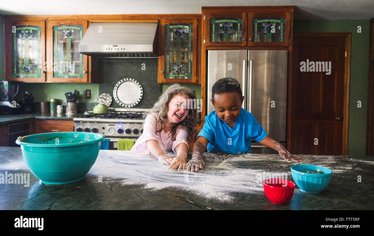 Kids making a mess in the kitchen Stock Photo - Alamy