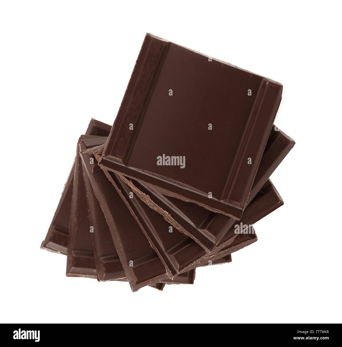 Pile of dark chocolate tiles isolated on white Stock Photo - Alamy