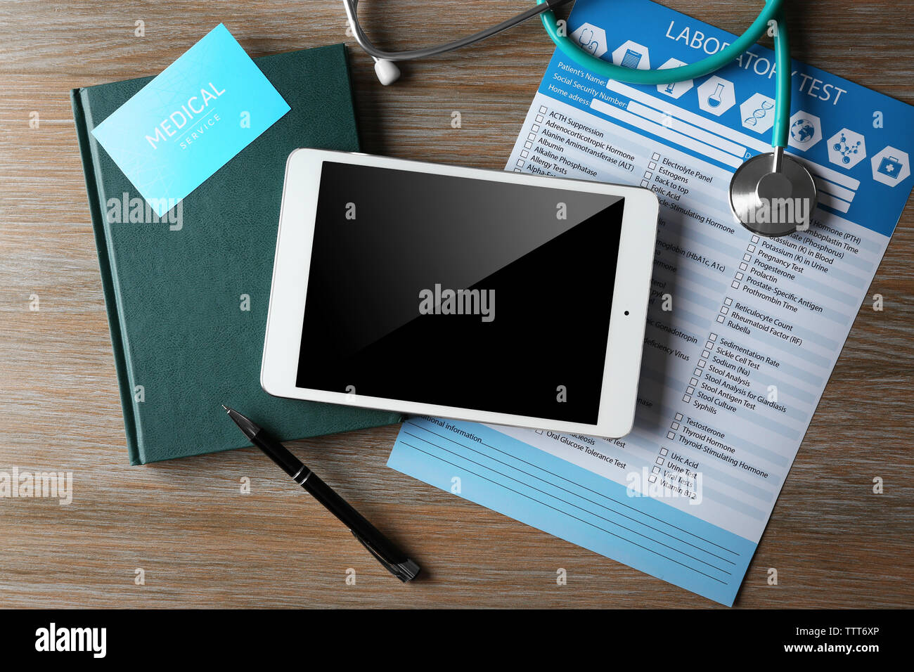 Stethoscope, tablet and laboratory test list on wooden table Stock ...