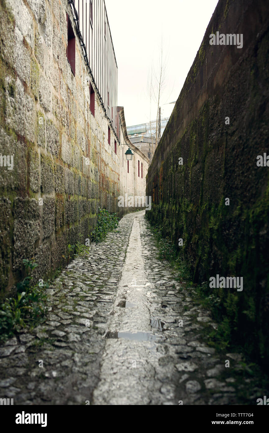 Narrow pathway amidst walls Stock Photo - Alamy