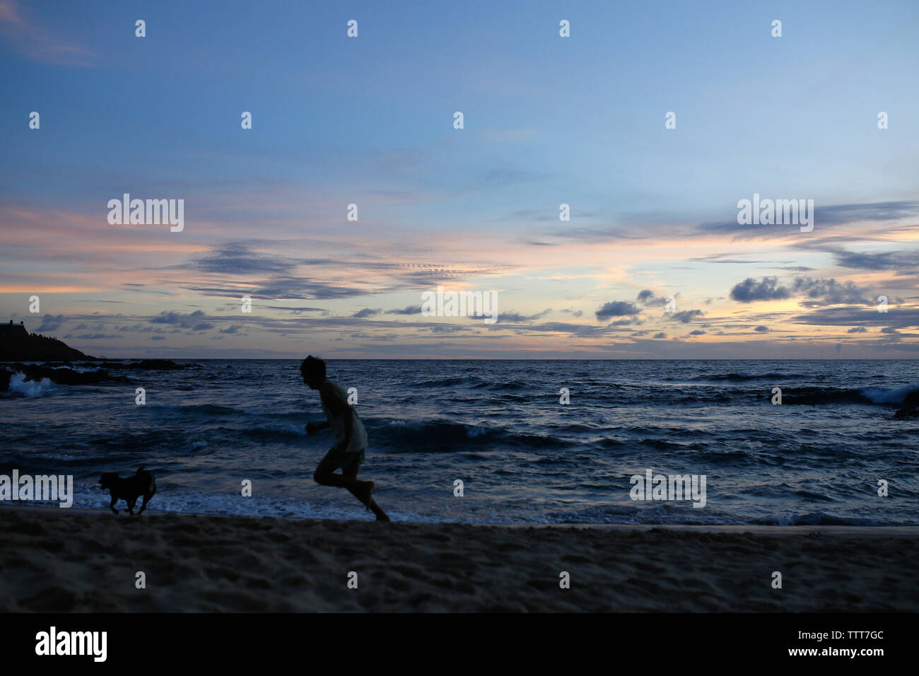 Man running into waves hi-res stock photography and images - Alamy