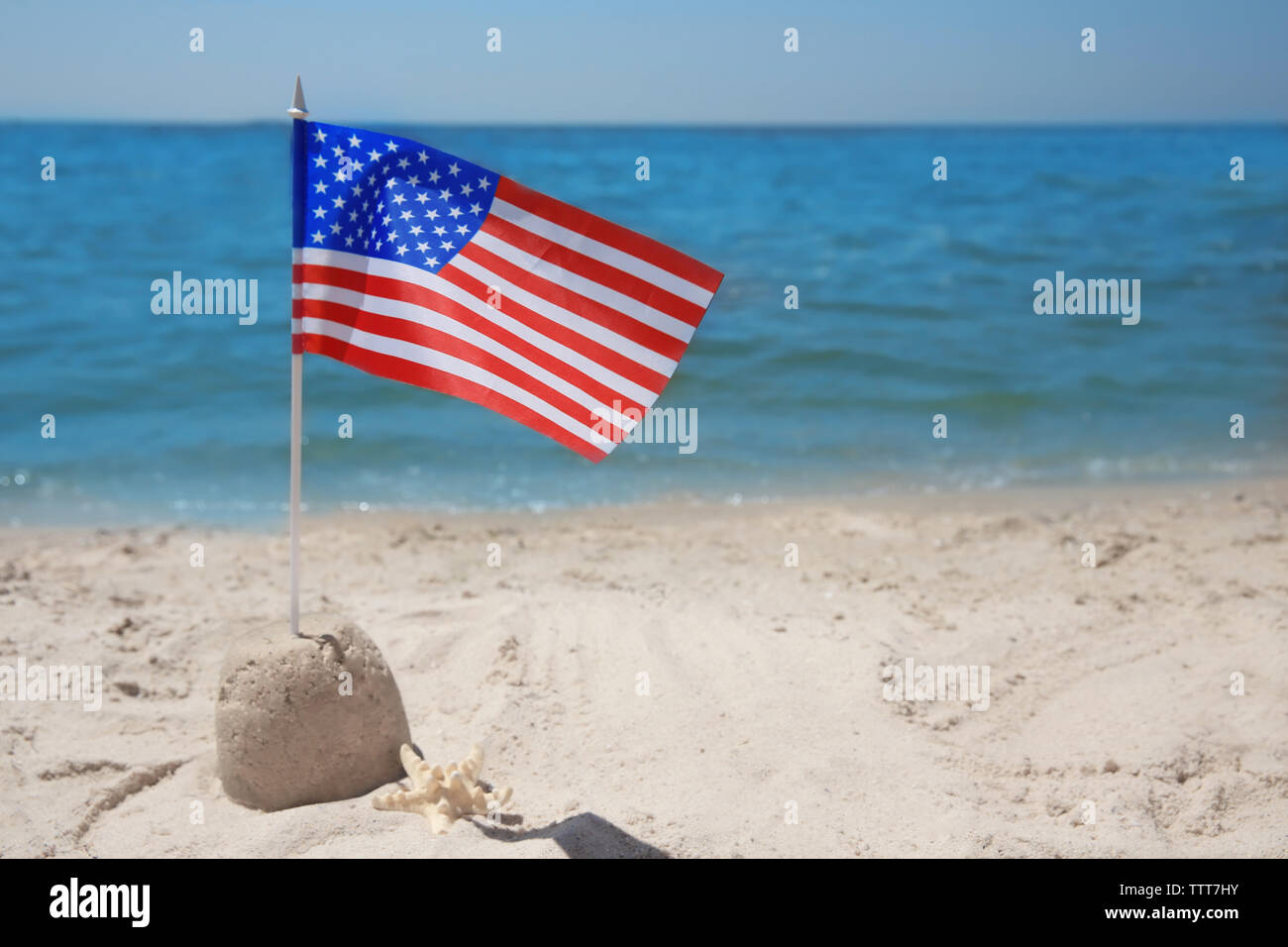 American flag with sand castle on beach Stock Photo - Alamy