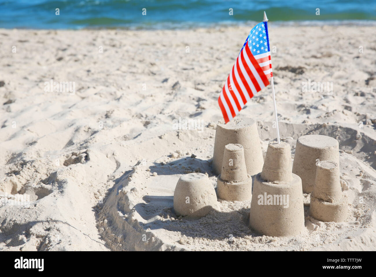 Sand castle with American flag on beach Stock Photo - Alamy