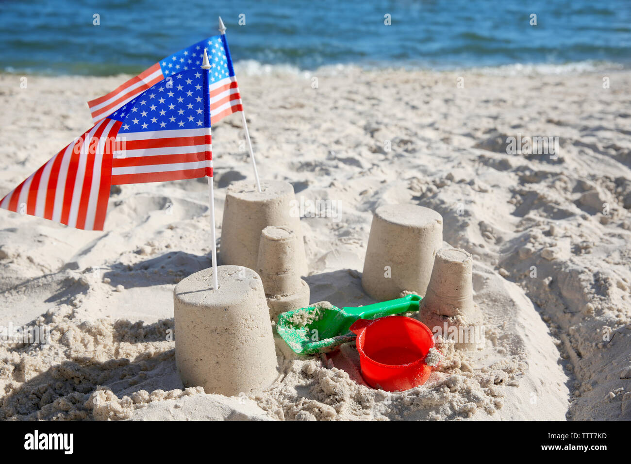 Sand castle with American flags on beach Stock Photo - Alamy