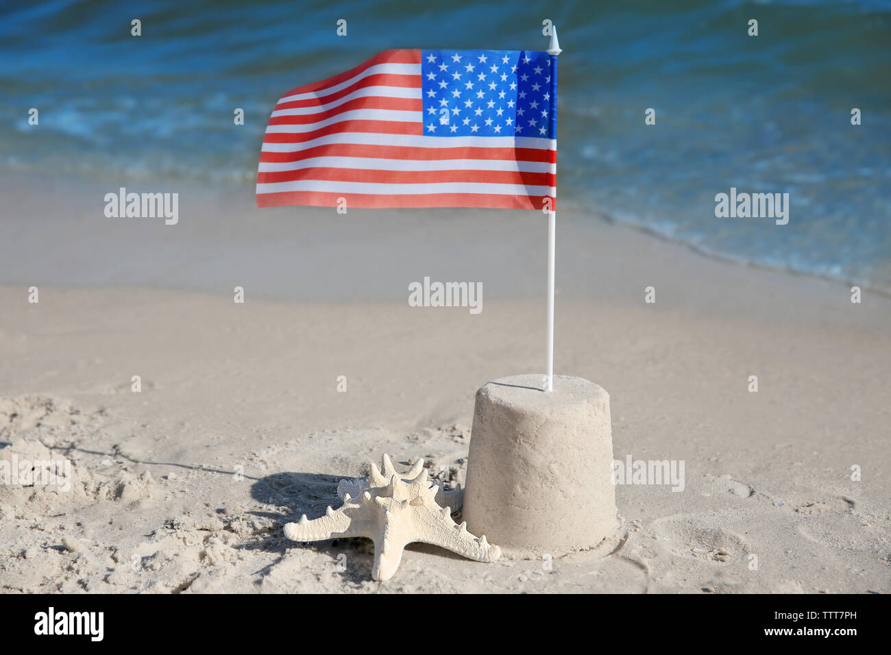 Sand castle with American flag on beach Stock Photo - Alamy