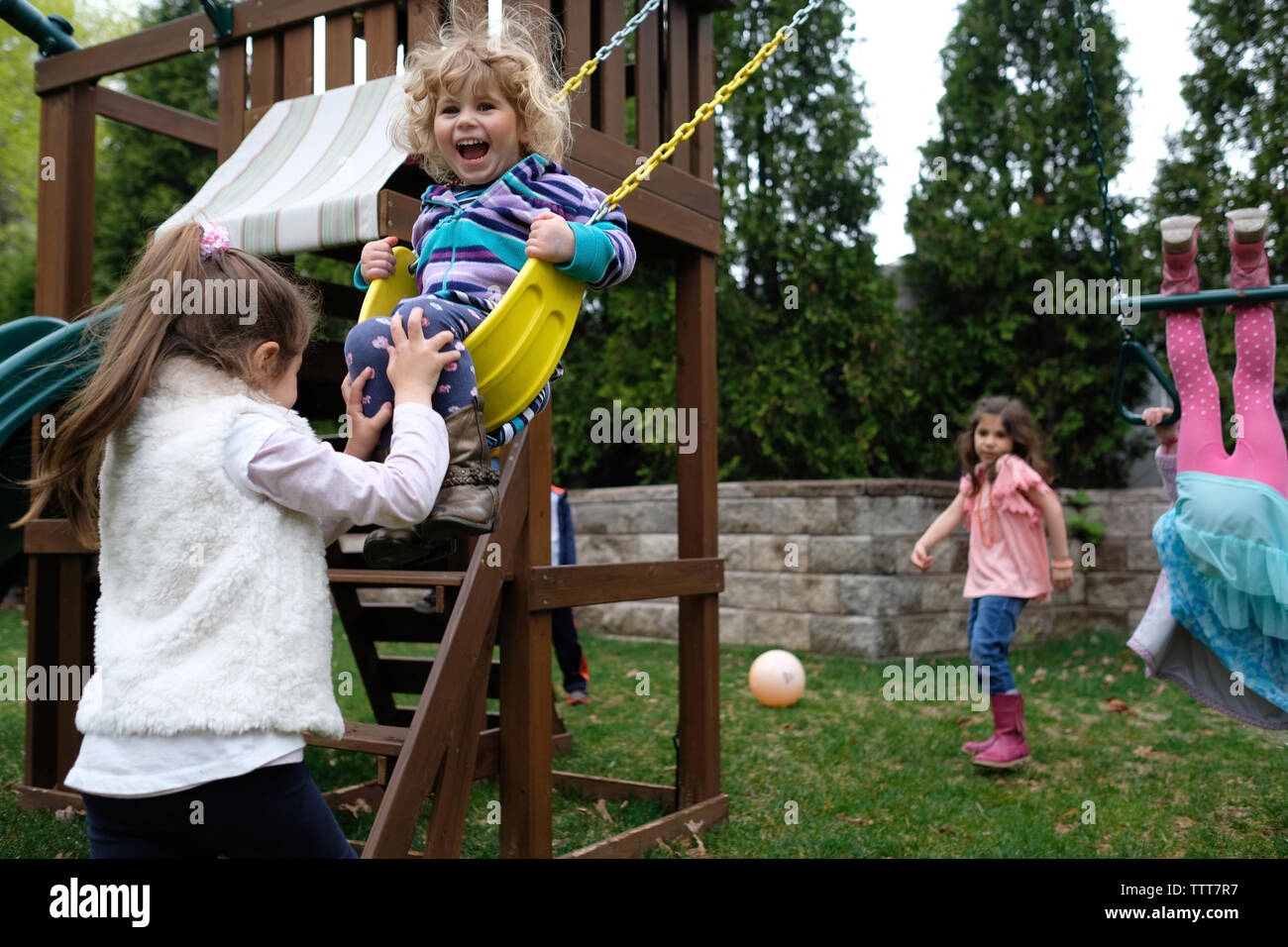 Happy friends playing at playground Stock Photo - Alamy