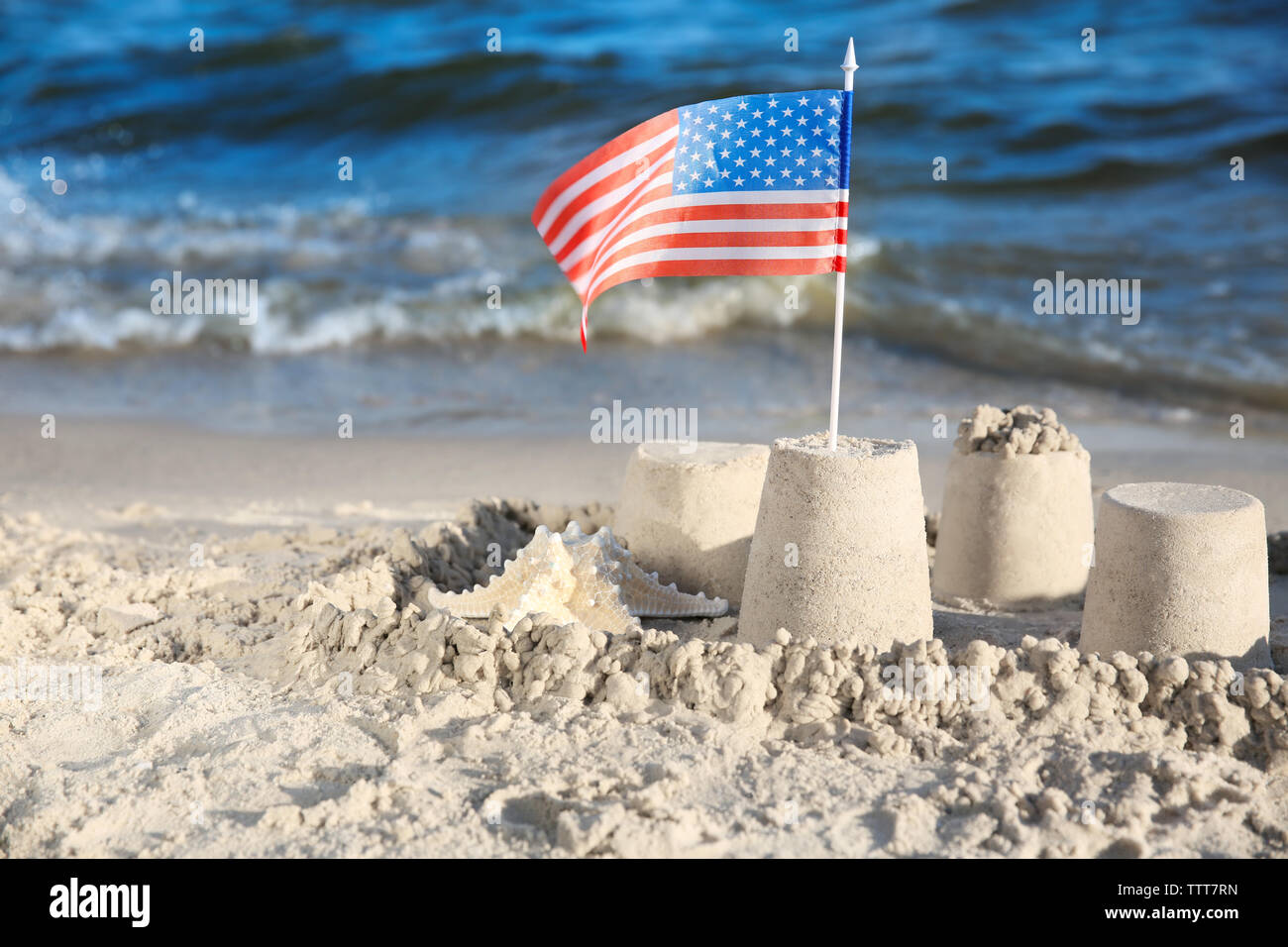 Sand castle with American flag on beach Stock Photo - Alamy