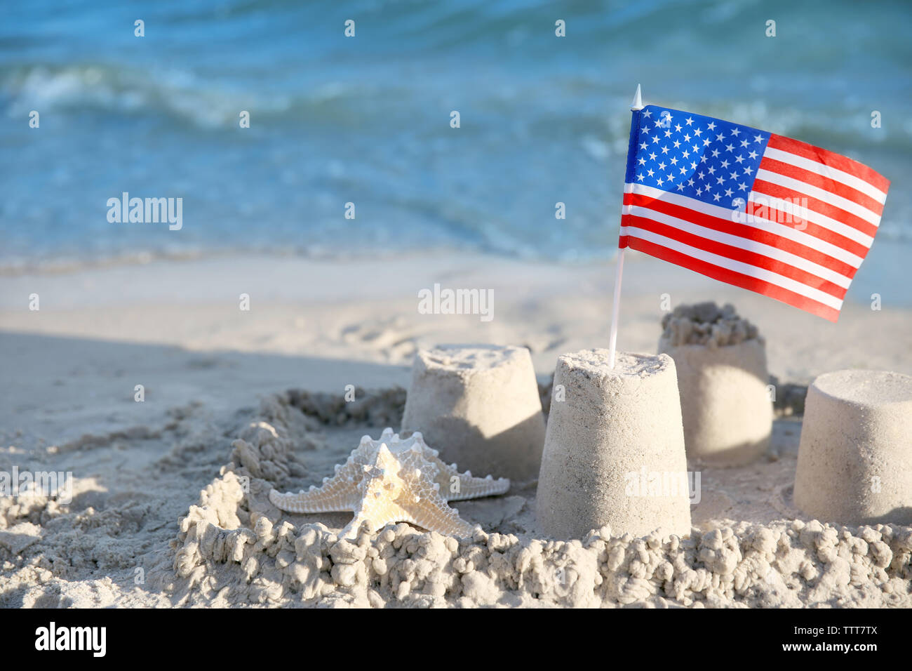 Sand castle with American flag on beach Stock Photo - Alamy