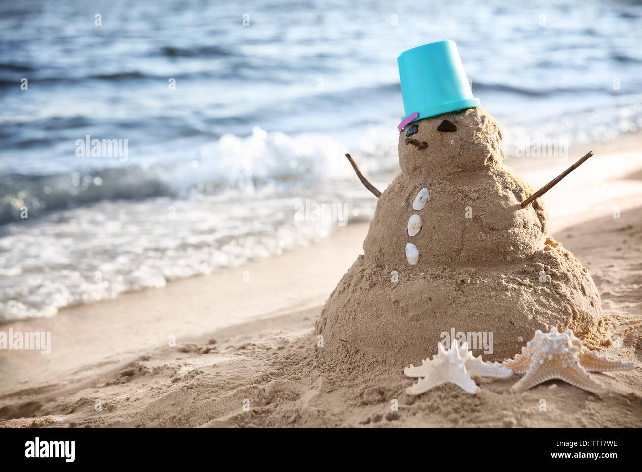 Snowman made of sand on beach Stock Photo - Alamy